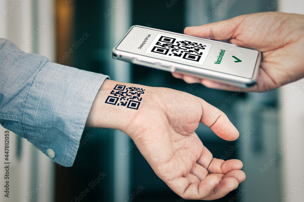 man shows his hand with a qr code, a confirmation of the vaccination ...