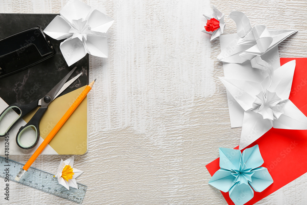 Frame made of origami daffodils and stationery on light background ...