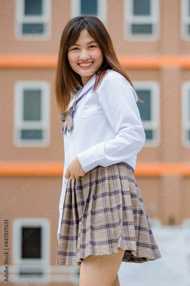 Full length portrait of young attractive female asian high school ...