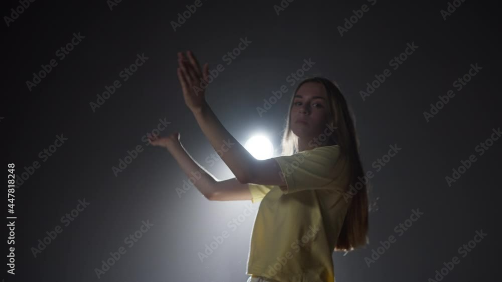 Professional choreographer woman dancing contemporary on dark ...