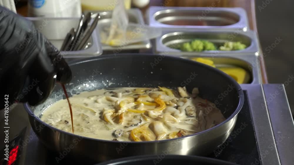 Cook prepares the dish in a boiling pan Stock Video | Adobe Stock