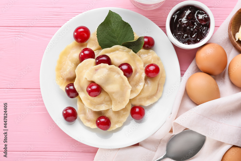 Composition with tasty cherry dumplings on color wooden background ...