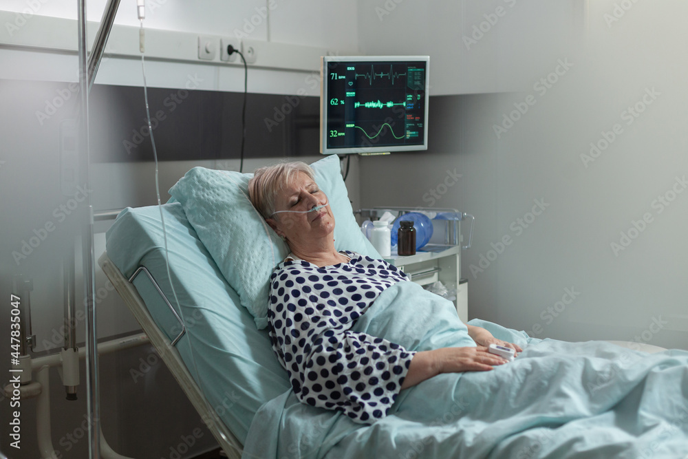 Senior woman patient in hospital room getting medicine through ...