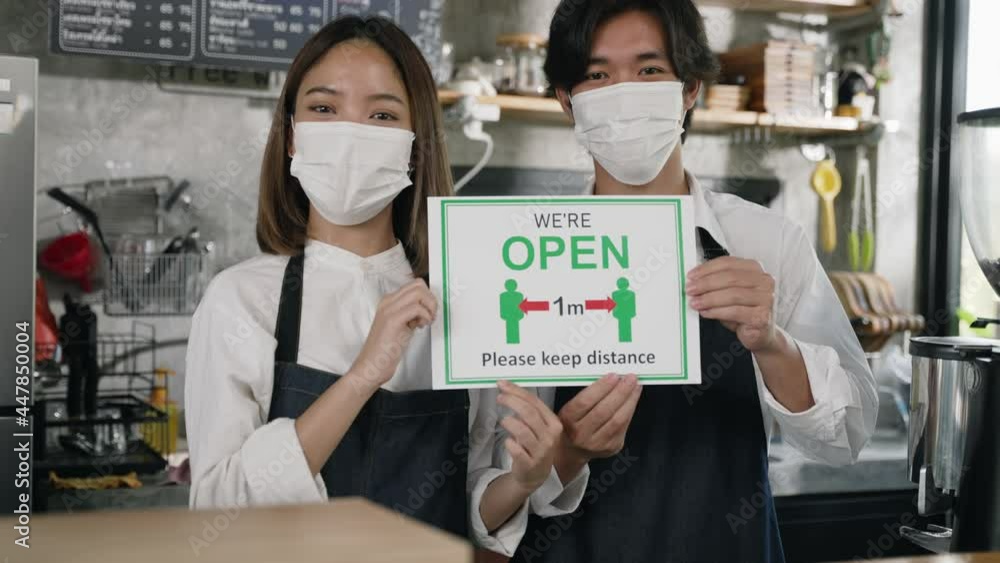 Couple coffee shop staff wearing surgical facemask showing social ...