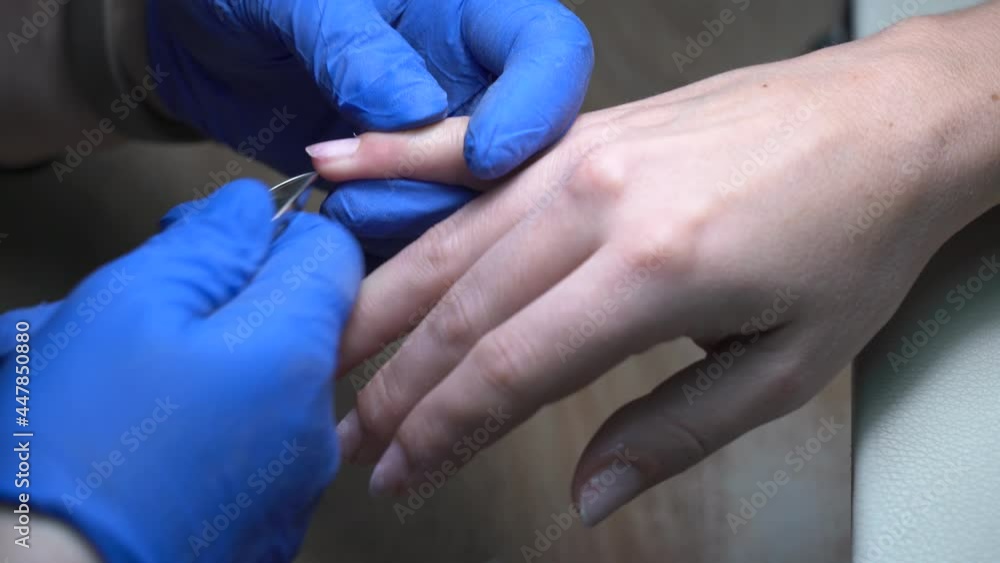 Process of removing skin cuticle of finger nails of female client in ...