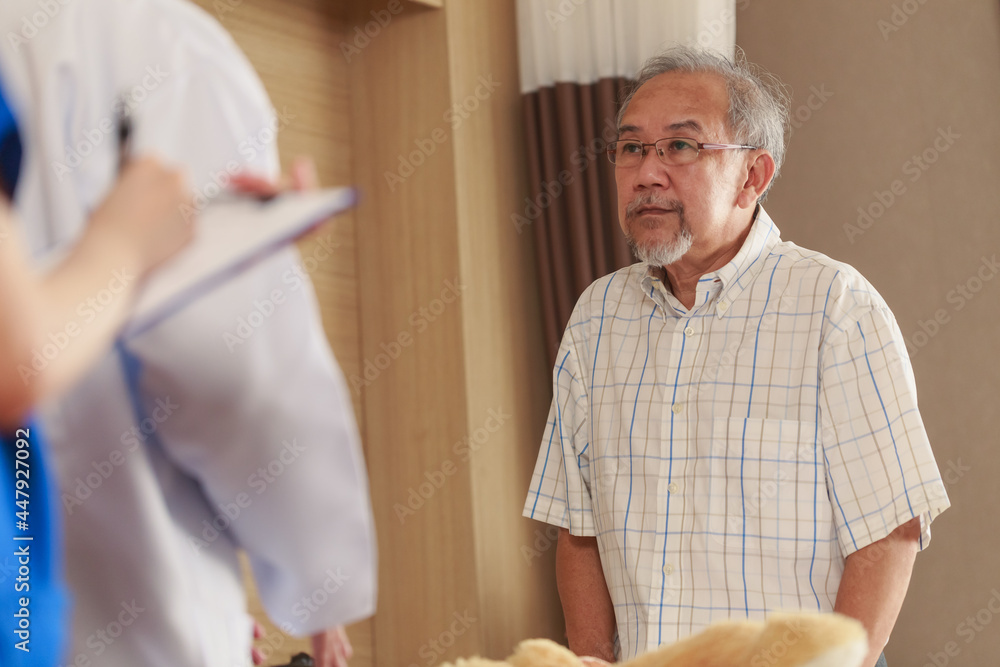 Asian measure man with grey hair look at his kid laying on the hospital ...