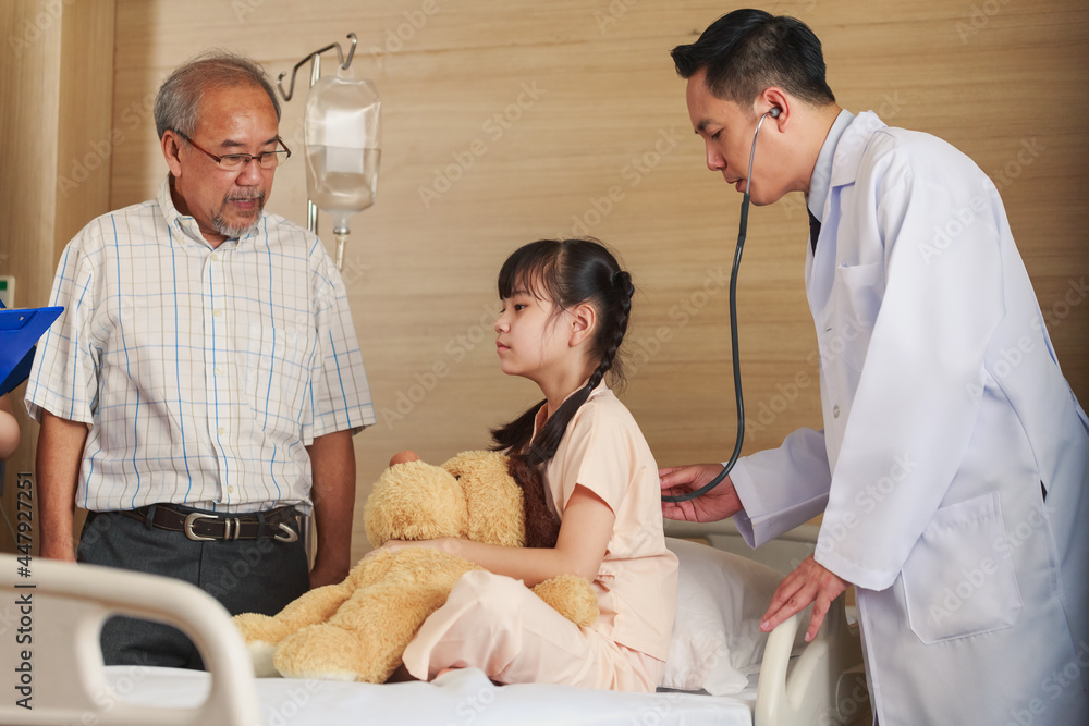 Asian Pediatrician man doctor consulting sick girl patient listening ...