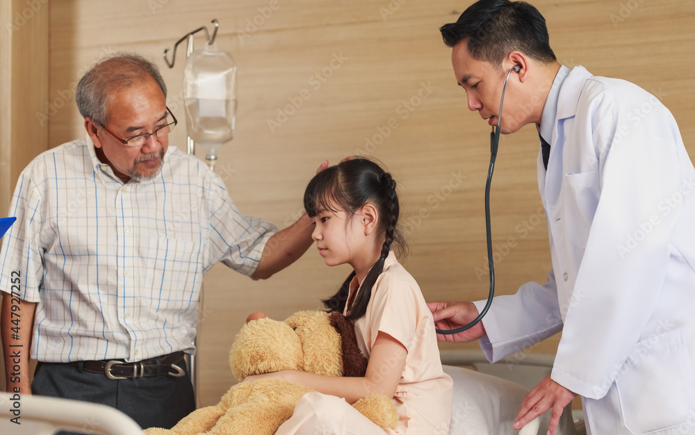Asian Pediatrician man doctor consulting sick girl patient listening ...