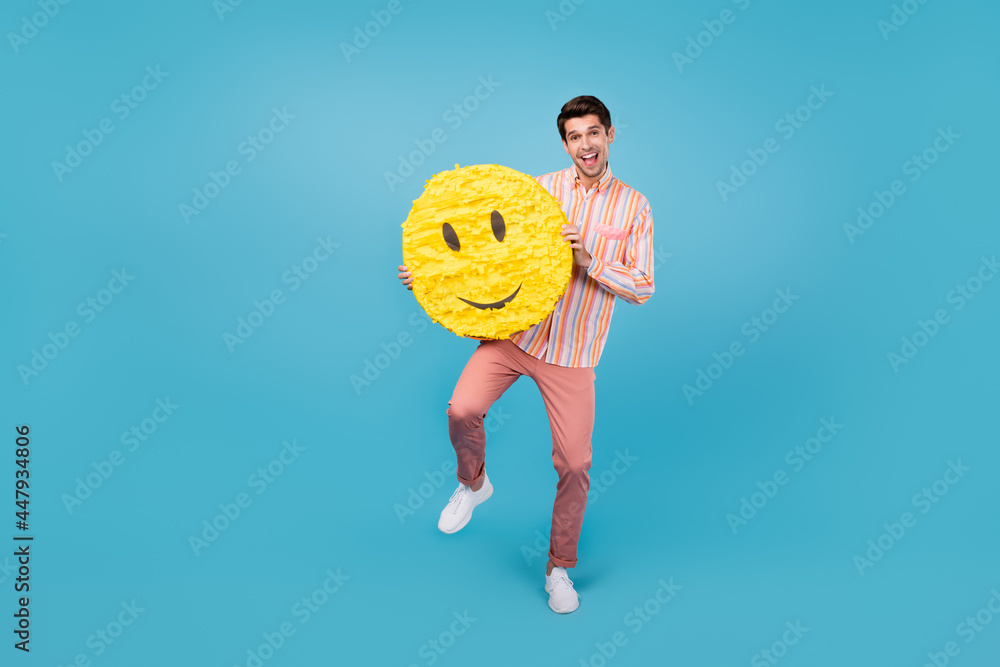 Full body photo of charming happy joyful positive man hold hands emoji ...