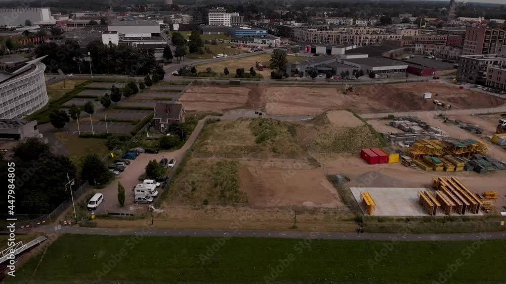 Slow sideways pan showing construction site at riverbank of river ...