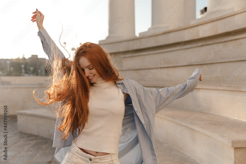 Cute foxy lady dancing outdoors at sunny day. Adorable young long ...