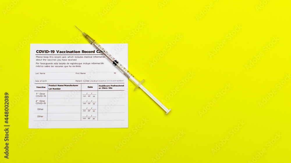 Medical syringe on paper of covid-19 vaccination record card used for ...
