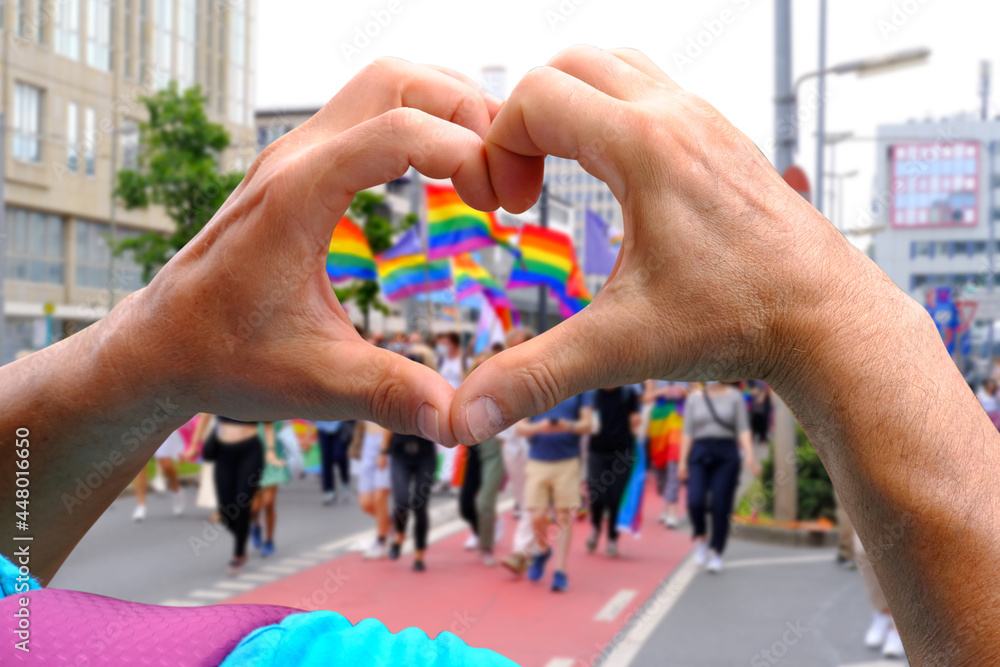 members of LGBTq movement, Gay pride parade in city with rainbow flags ...