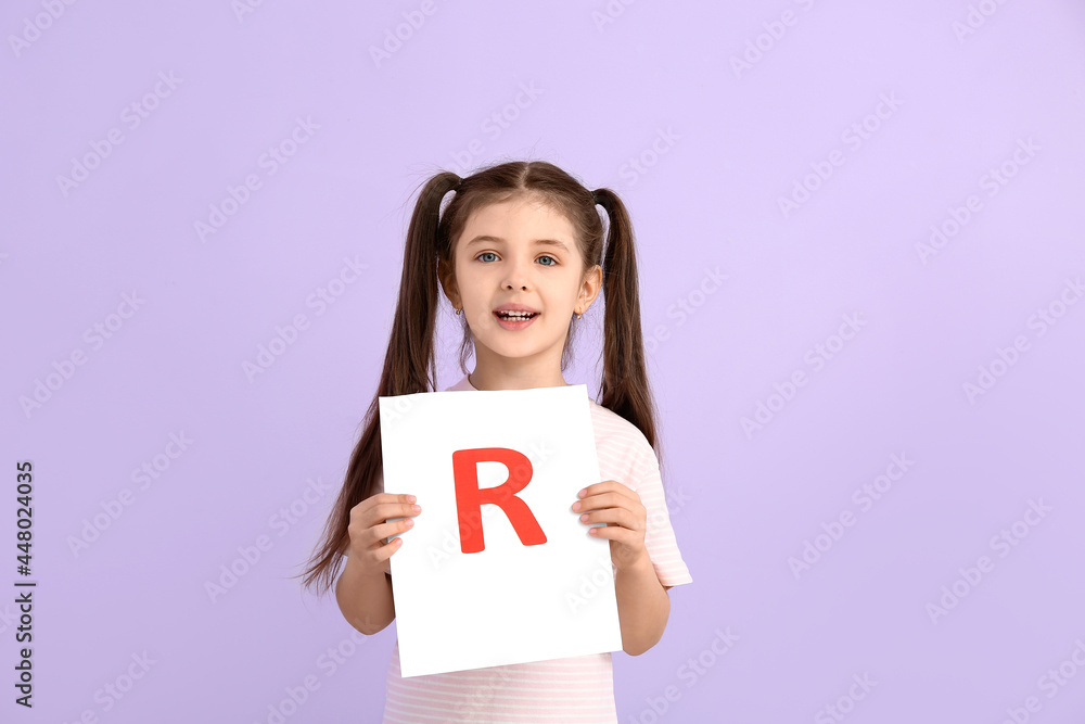 Little girl holding paper sheet with letter R on color background Stock ...