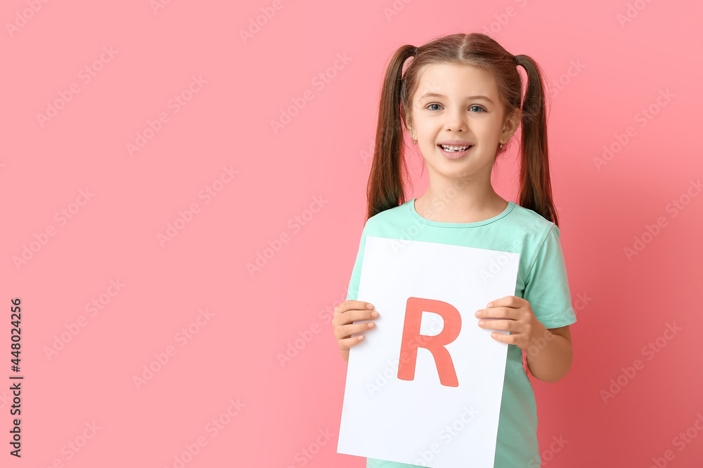 Little girl holding paper sheet with letter R on color background Stock ...