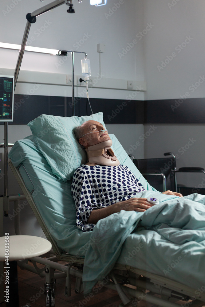 Senior man suffering after serious accident laying in hospital bed ...