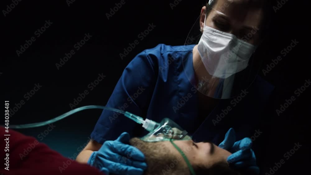 Doctor wearing medical uniform and face shield checking sick patient ...