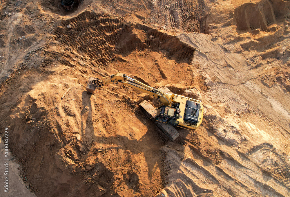 Excavator dig trench in ground at construction site. Foundation pit for ...