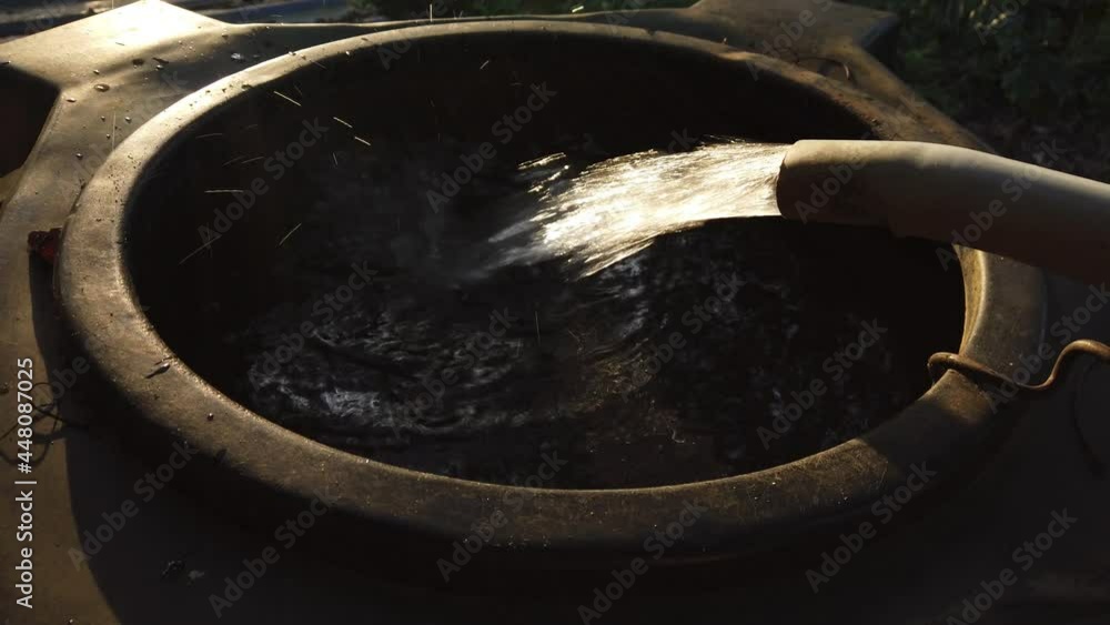 Water tank overflowing. Filling with water in a tank. Water pumping to ...