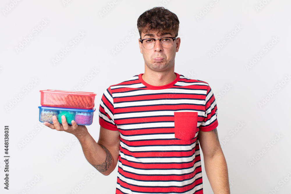 young handsome man feeling sad and whiney with an unhappy look and ...
