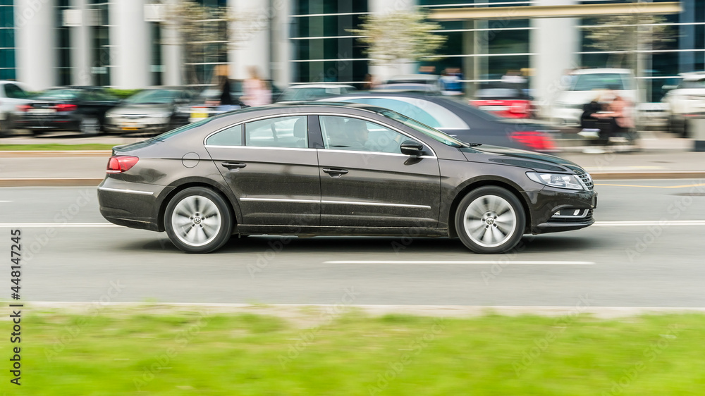 Volkswagen Passat CC Facelift car moves on a multi-lane road. Modern ...