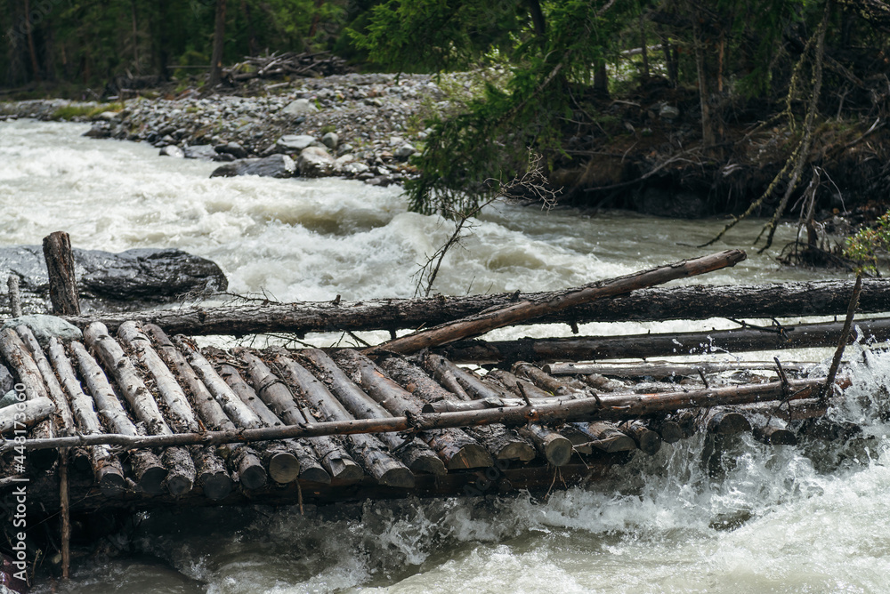 Fast turbulent river with broken bridge in water. Scenic mountain ...
