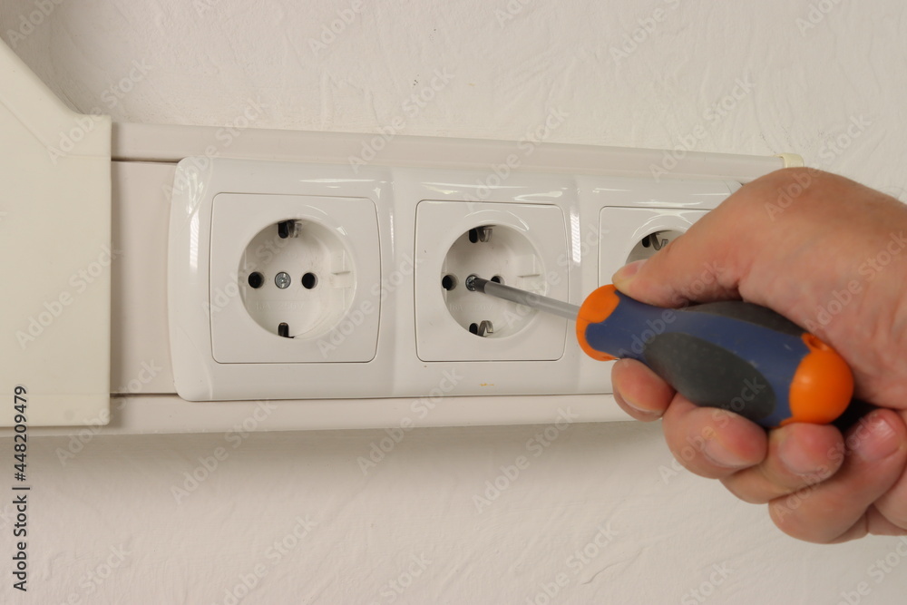 Installation of an electrical connector in a cable channel in an office ...
