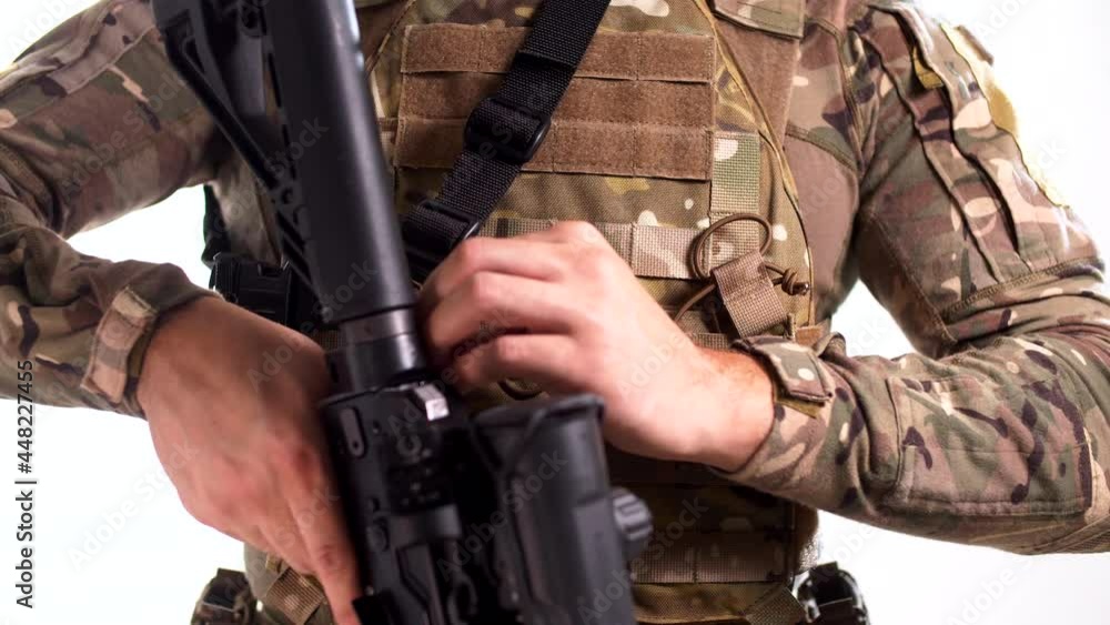 Soldier in modern military outfit picks up a Kalashnikov assault rifle ...