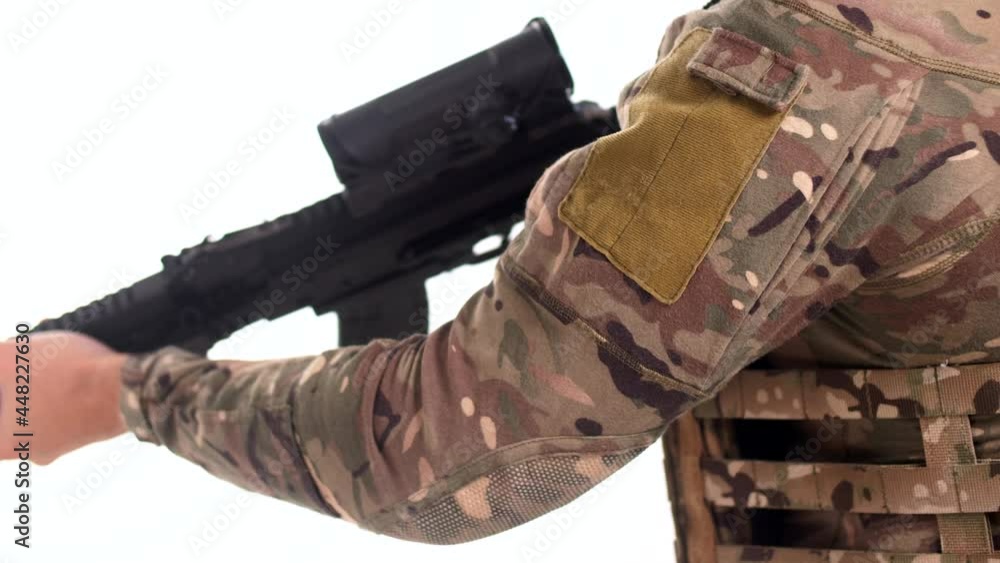 Soldier dressed in modern military outfit, raising his modern rifle ...