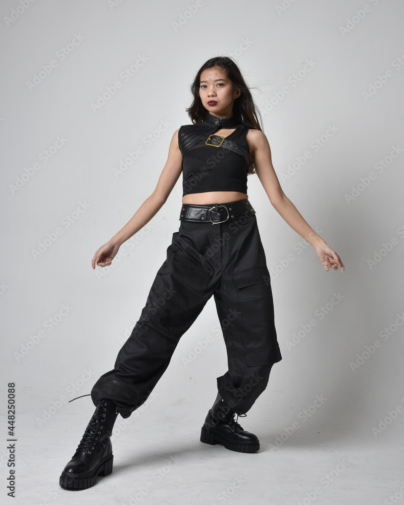 Full length portrait of pretty young asian girl wearing black tank top ...