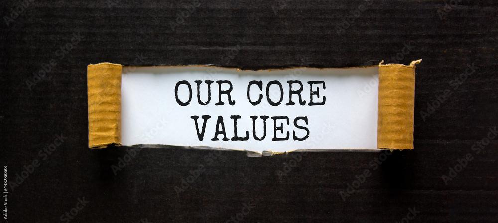 Our core values symbol. Words 'Our core values' appearing behind torn ...
