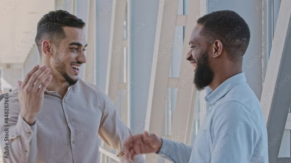 Two multiracial colleagues business men african american guy and ...