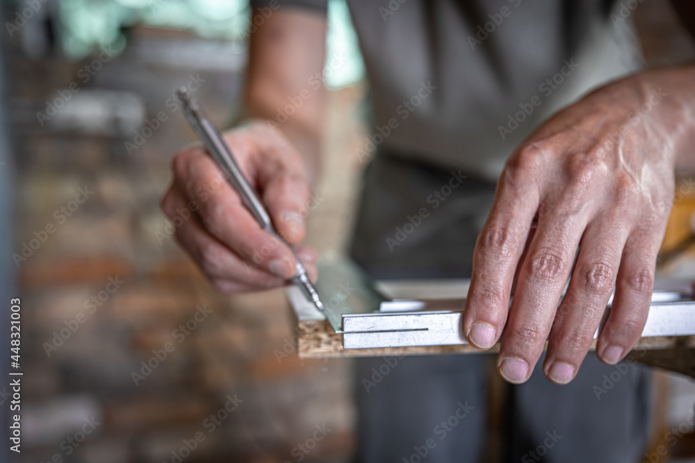 The carpenter marks the piece of wood with a pen and ruler. Stock Photo ...