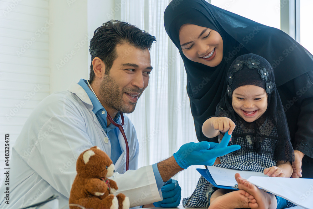 Health care concept. Muslim mother wear hijab with own little daughter ...