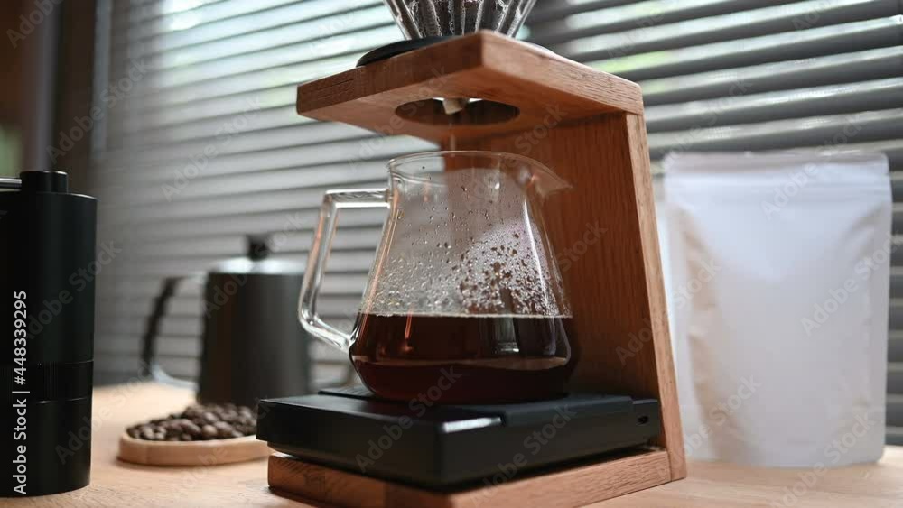 Close up hand drip coffee by spilling hot water through a layer of ...