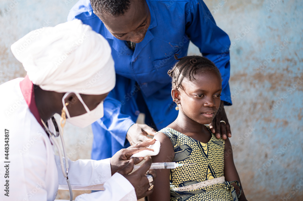 Relieved little African girl looked after by the vaccination staff ...