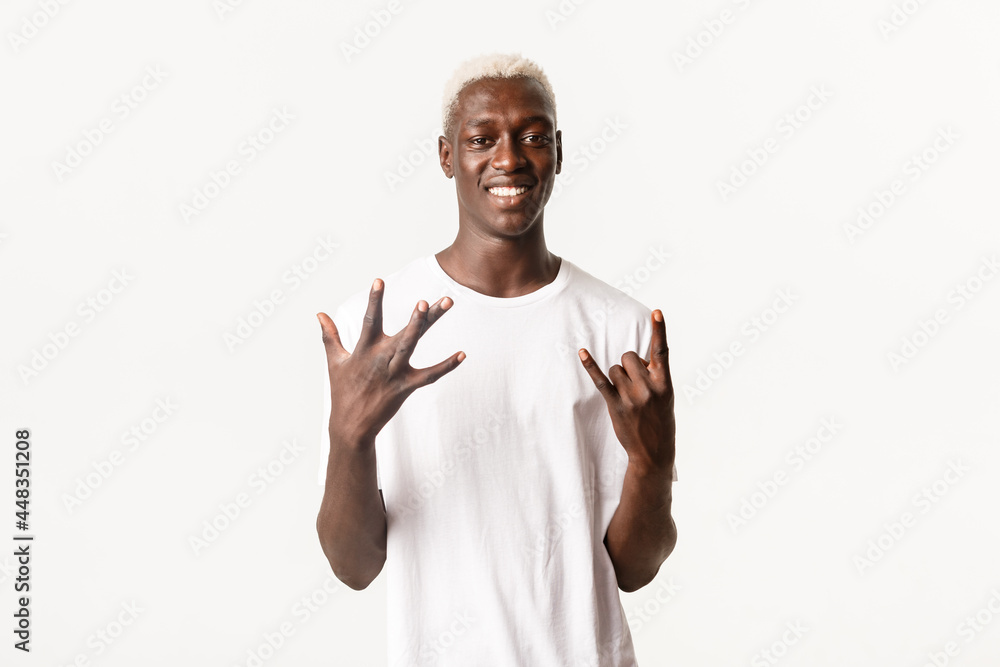 Portrait of stylish african-american blond guy showing west coast hand ...