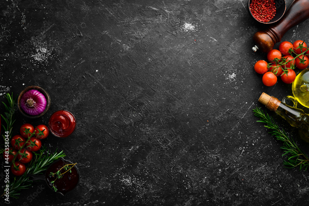 Black stone cooking background. Spices and vegetables. Top view. Free ...