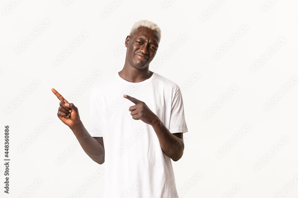 Portrait of skeptical and unamused african-american blond guy, tilt ...