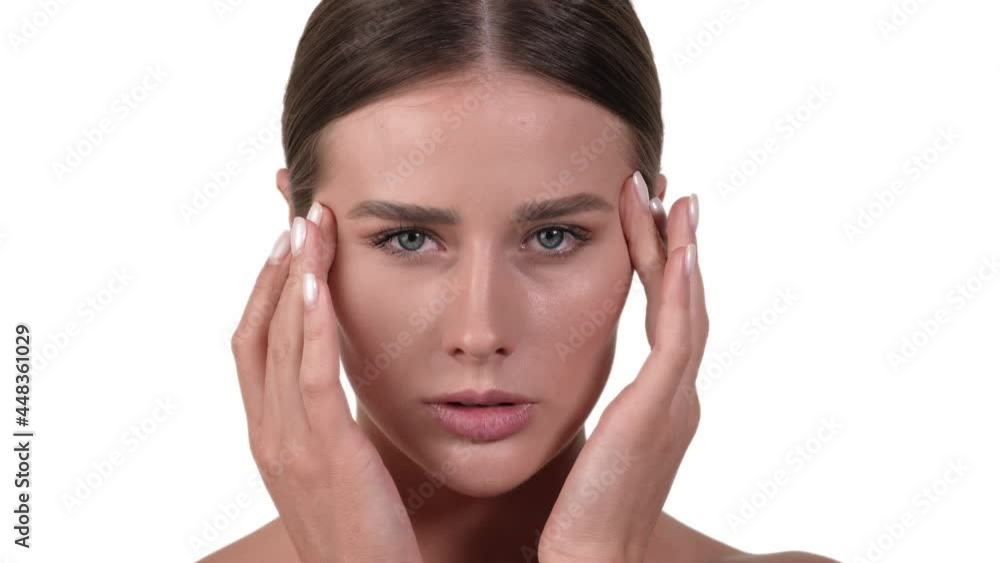 Portrait of a Caucasian woman, examining her skin for a wrinkles ...