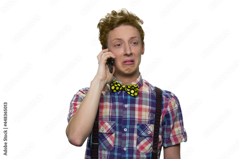 Portrait of teenage boy is talking on phone with facial expression of ...
