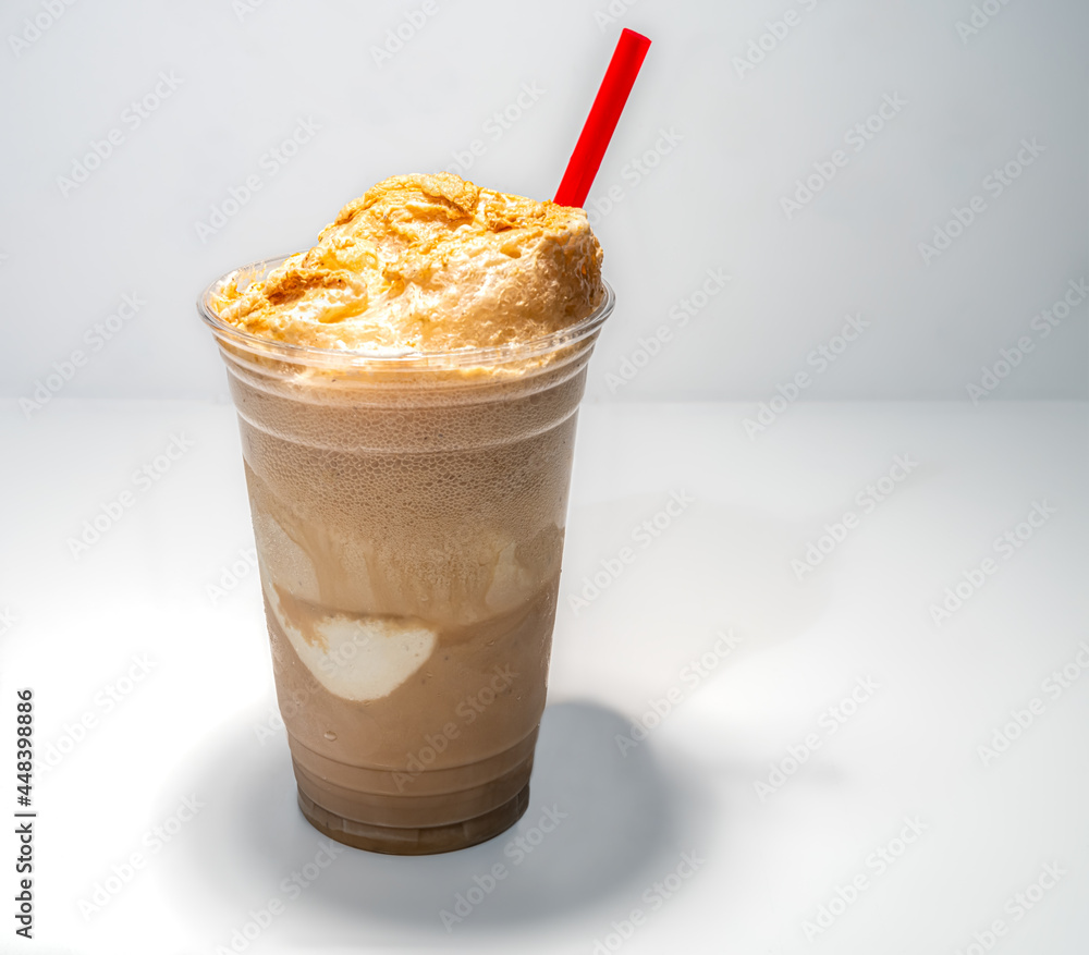 Delicious old fashioned frothy Root Beer Float in a clear plastic cup ...