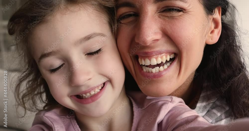 Close up head shot cute small preschool kid girl recording funny selfie ...