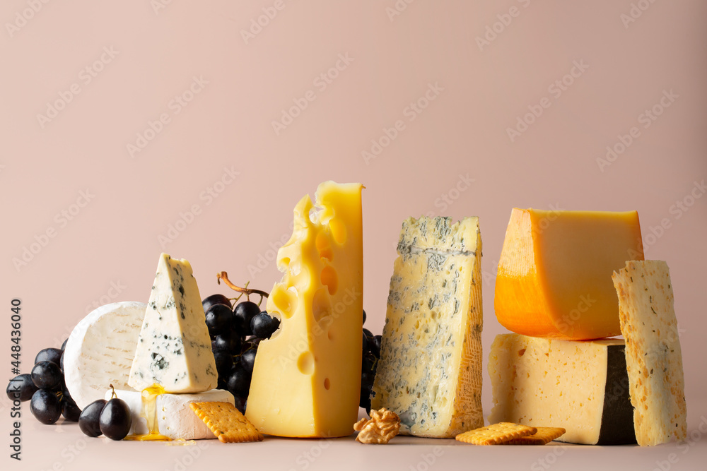 Different types of cheese on pastel pink light background. Cheeses mix ...