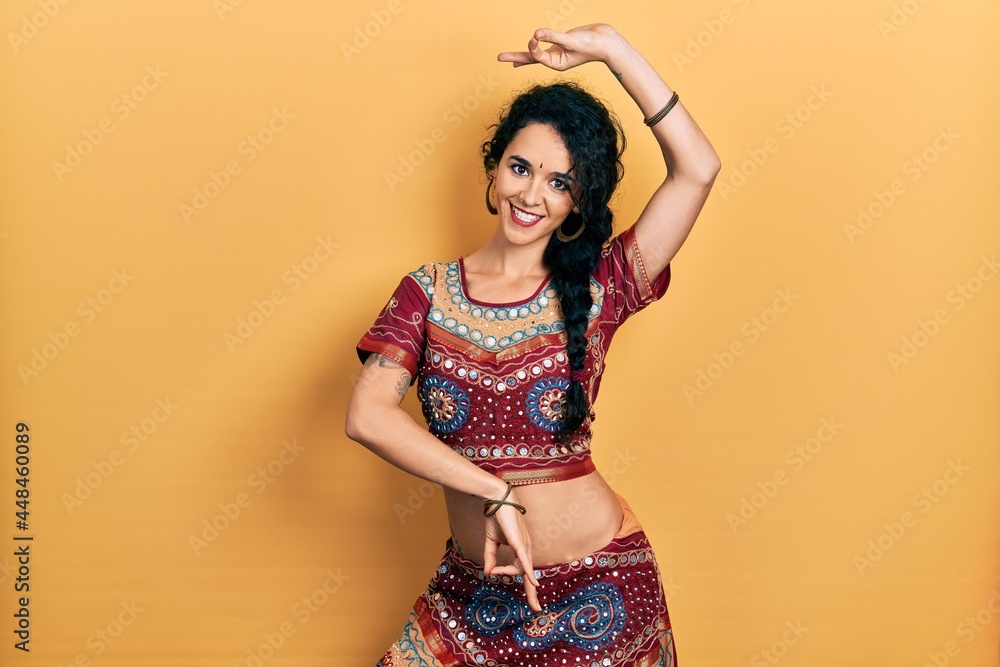 Young indian woman wearing traditional belly dancer costume. Dancing ...