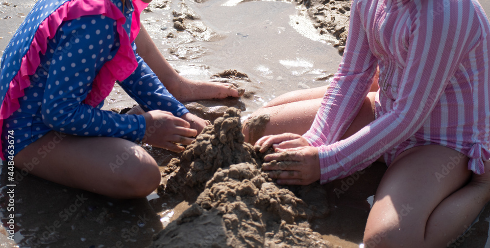 Children playing in the sand, getting messy, sitting on the beach, in ...