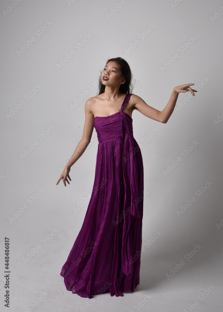 Full length portrait of pretty brunette asian girl wearing purple ...