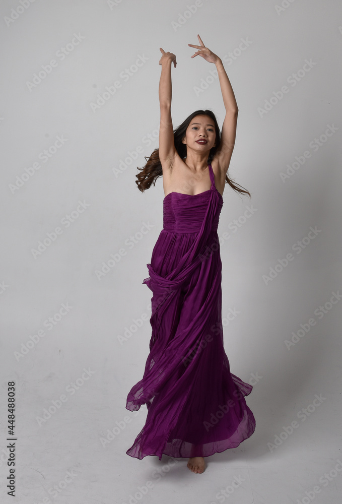 Full length portrait of pretty brunette asian girl wearing purple ...