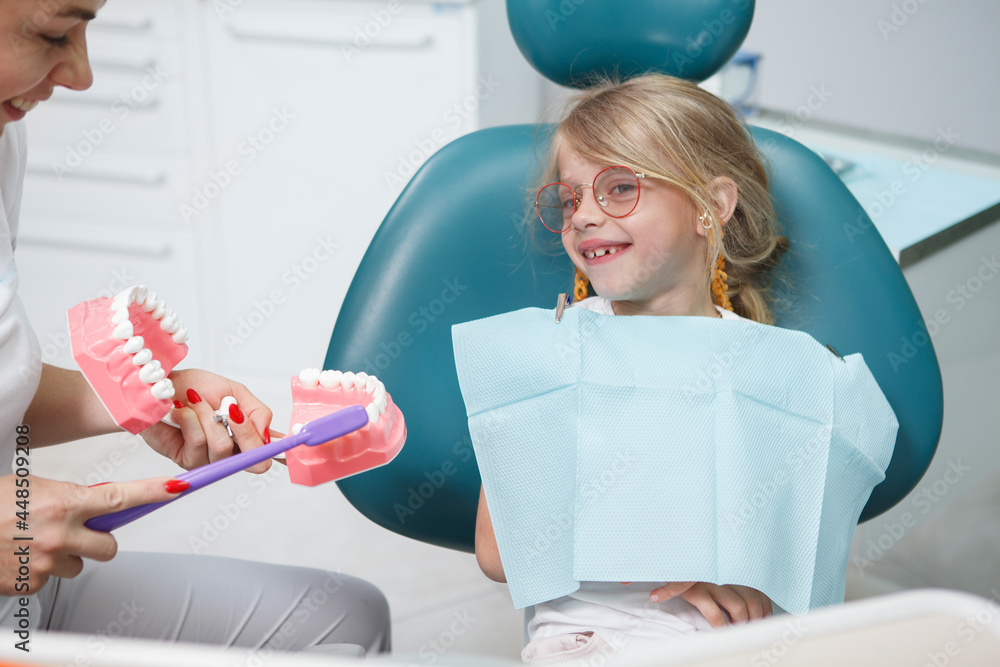 Adorable little girl learning brushing teeth from her dentist Stock ...