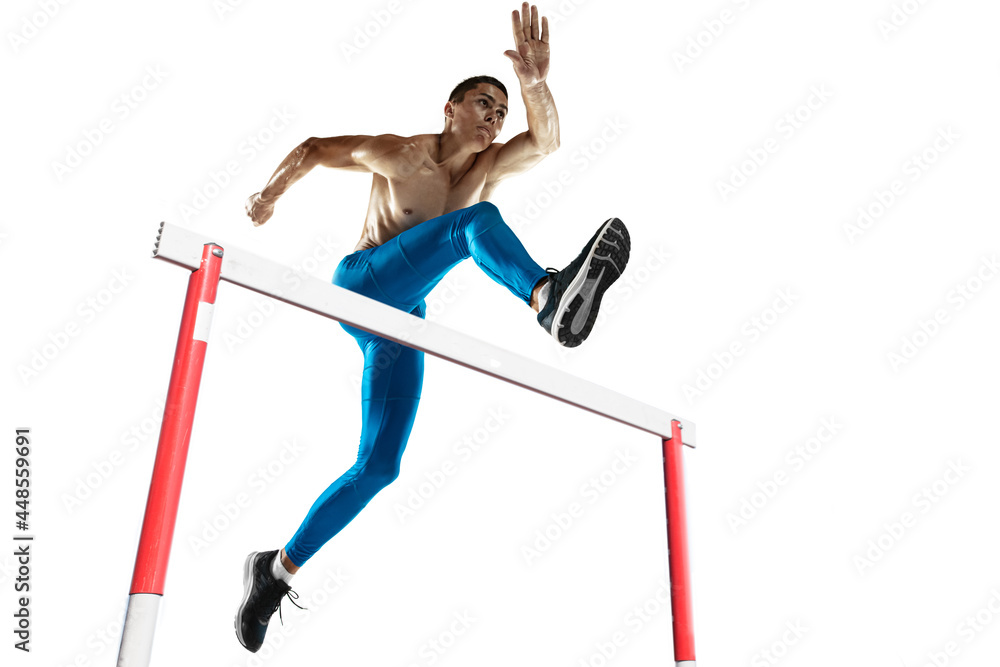 Steeplechase. Young male athlete, runner running, jumping isolated on ...
